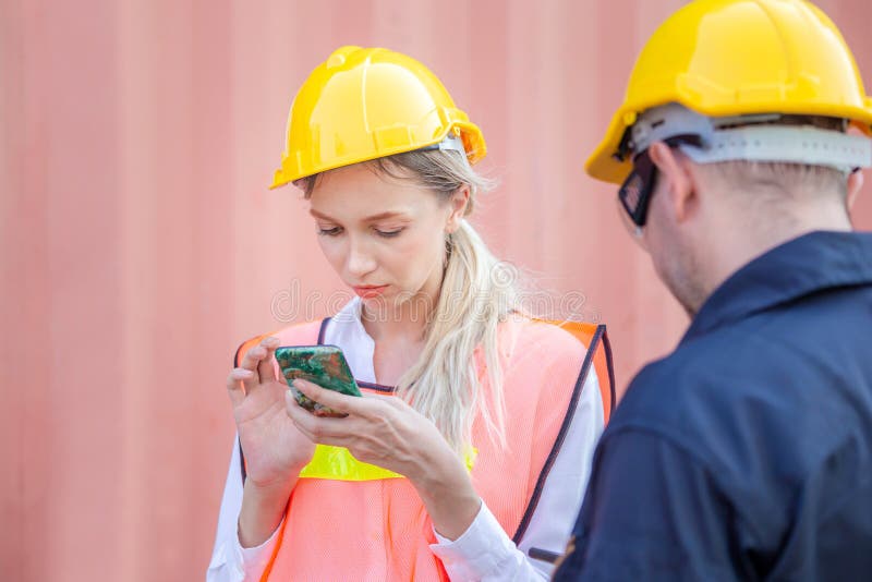 Engineer in the Hard Hat Uses Mobile Phone, Industrial Worker Using ...