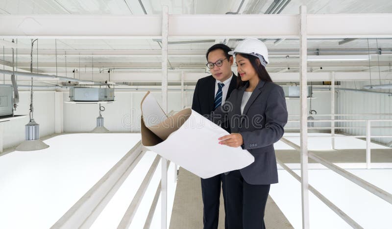 Engineer in Hardhat Hold the Ventilation System Construction Plan while ...