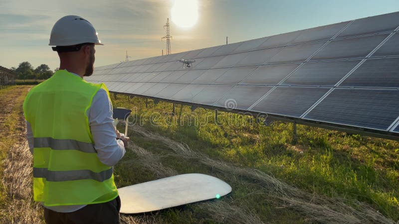 Engineer in Hardhat Holding Tablet Computer Operating Flying Drone in ...