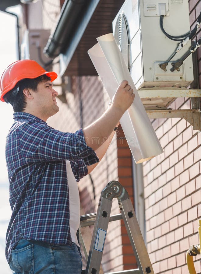 Engineer in Hardhat Looking in Plan of Air Conditioning System Stock ...
