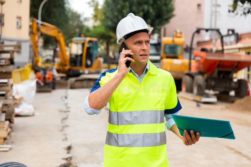 Engineer Having Telephone Conversation in Construction Area Stock Photo ...