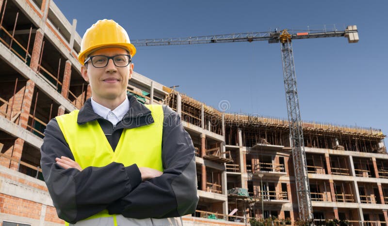Engineer in a Helmet on the Background of a Building Under Construction ...
