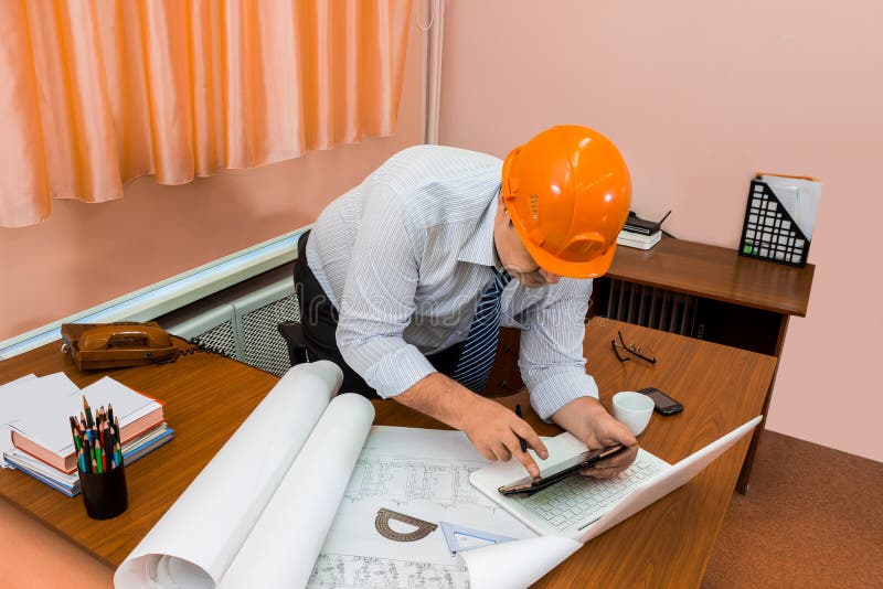 Engineer in Helmet Working with Drawings Stock Photo - Image of ...