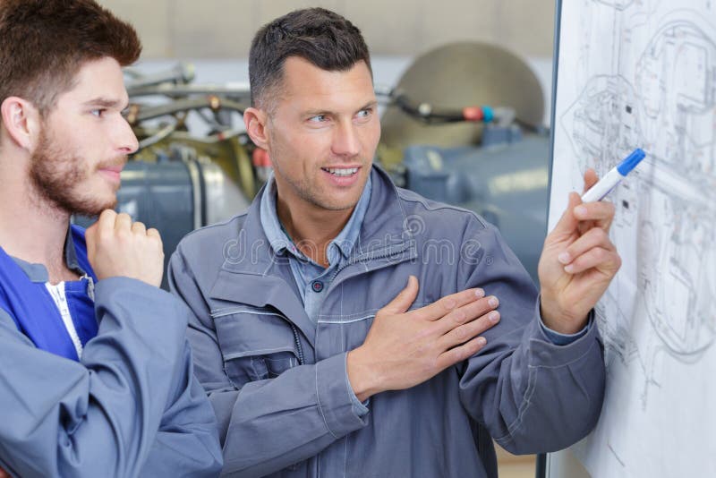 Engineer and Apprentice Looking at Detailed Drawings Stock Photo ...