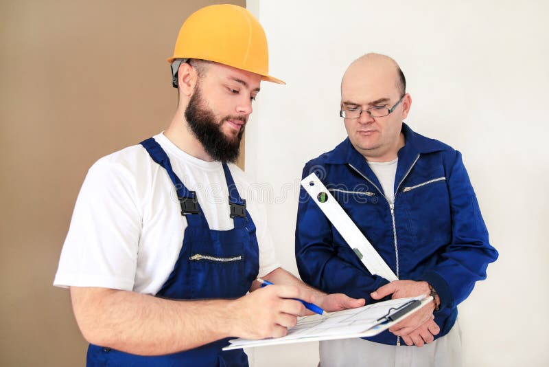 Engineer with His Colleague, Construction Worker is Measuring Wall ...