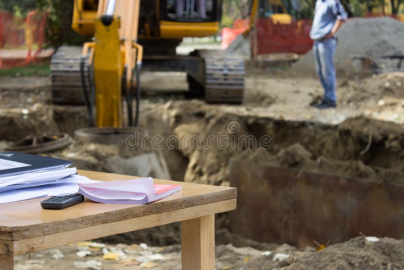 Engineer and His Working Desk with Work Orders, Site Engineer Co Stock ...