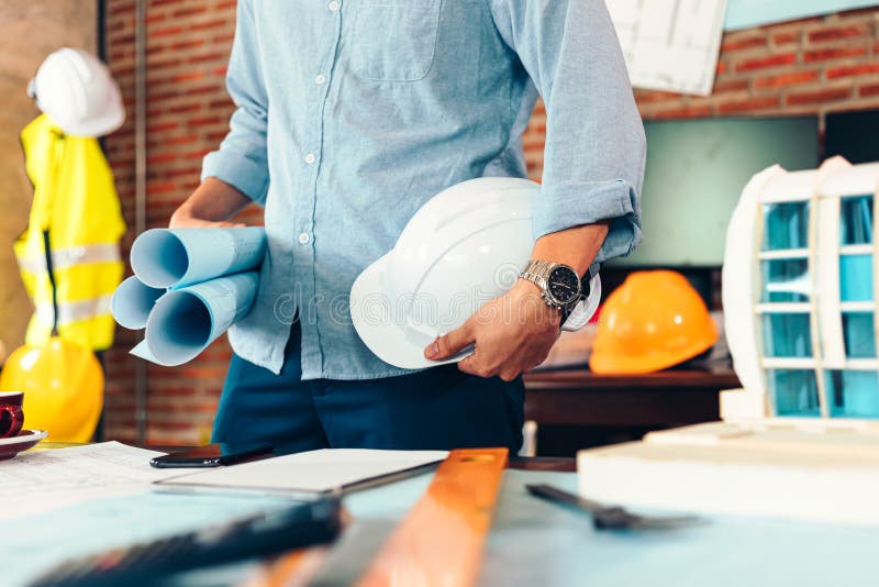 Engineer Hold Engineer Drawing Design Blueprints and Safety Helmet in ...