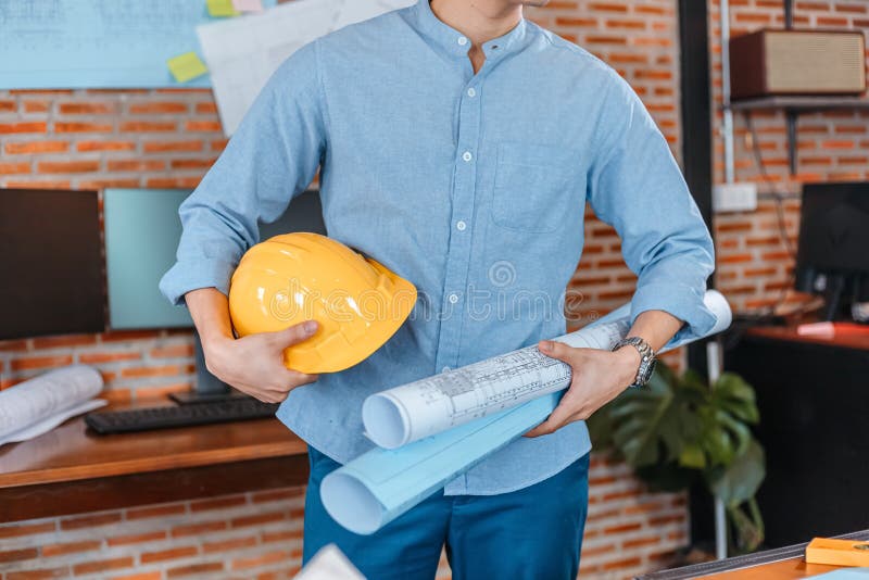 Engineer Hold Engineer Drawing Design Blueprints and Safety Helmet in ...