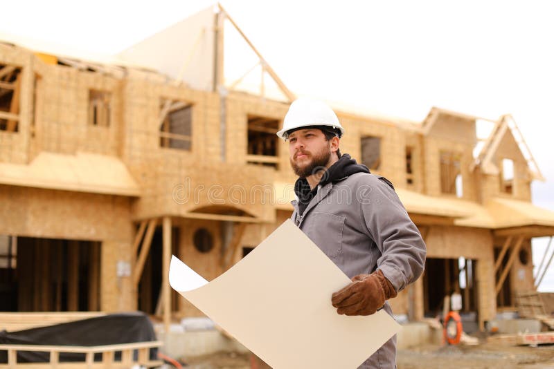 Engineer Holding Architecture Drawing Plan on Paper at Construction ...