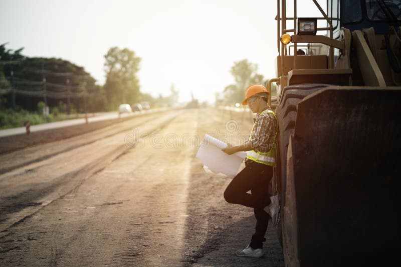 Engineer Holding Blueprint at Construction Site Stock Photo - Image of ...
