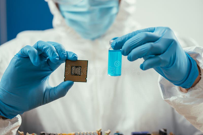 Engineer Holding Computer Microchip and Glass Container with Blue ...