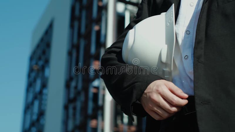 Engineer Holding a Construction Helmet Against the Backdrop of a ...