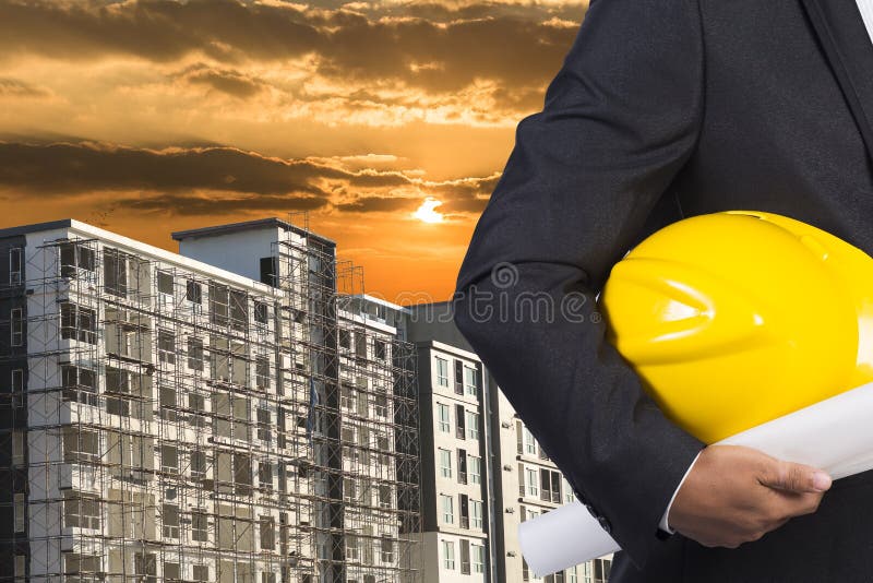 Engineer Holding Helmet for Working at Footing of Building Stock Photo ...