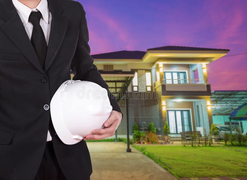 Engineer Holding Helmet with House Background Stock Image - Image of ...