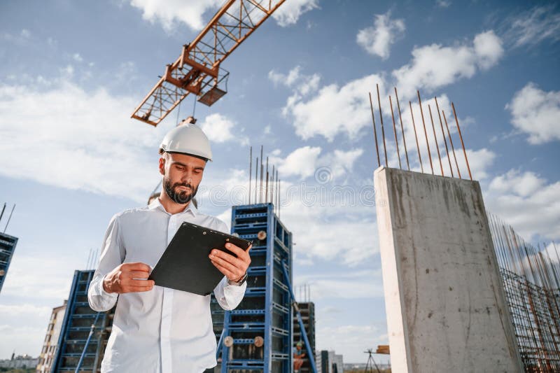 Engineer is Holding Notepad. Man in Uniform is Working on the ...