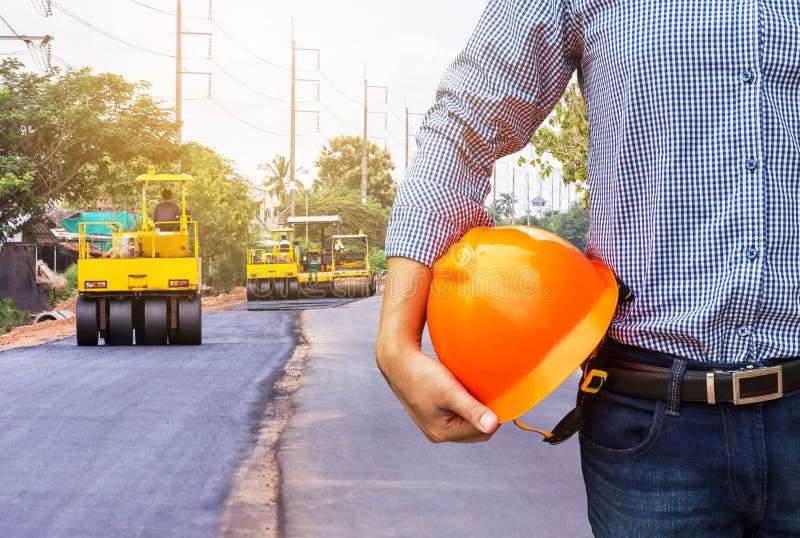 Engineer Holding Safety Helmet at Road Construction Site Stock Photo ...