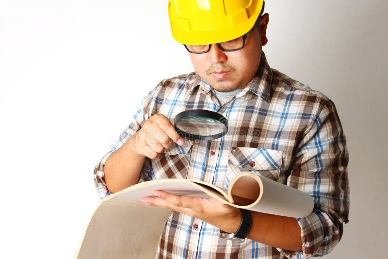 An Engineer Holds Construction Paper Using a Magnifying Glass Stock ...
