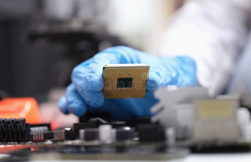Engineer Holds in Hands Powerful Processor or Board after Repair Stock ...
