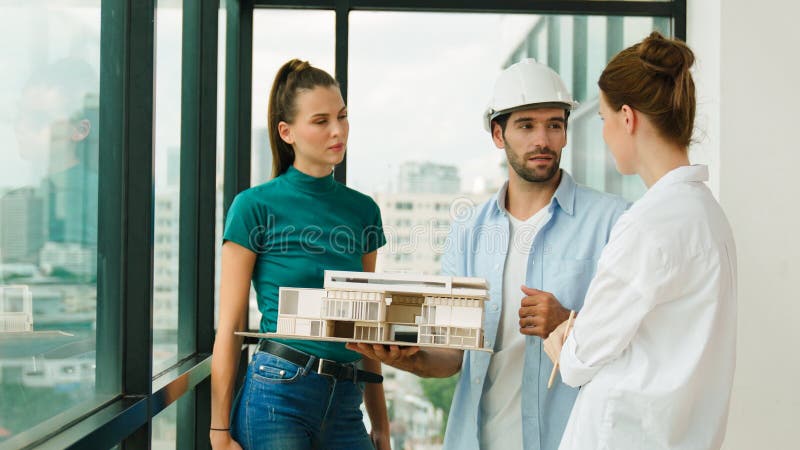 Engineer Holds House Model and Explain about House Construction ...