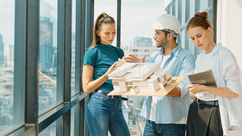 Engineer Holds House Model and Explain about House Construction ...