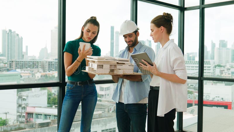 Engineer Holds House Model and Explain about House Construction ...