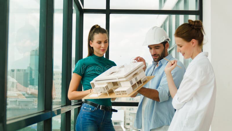 Engineer Holds House Model and Explain about House Construction ...