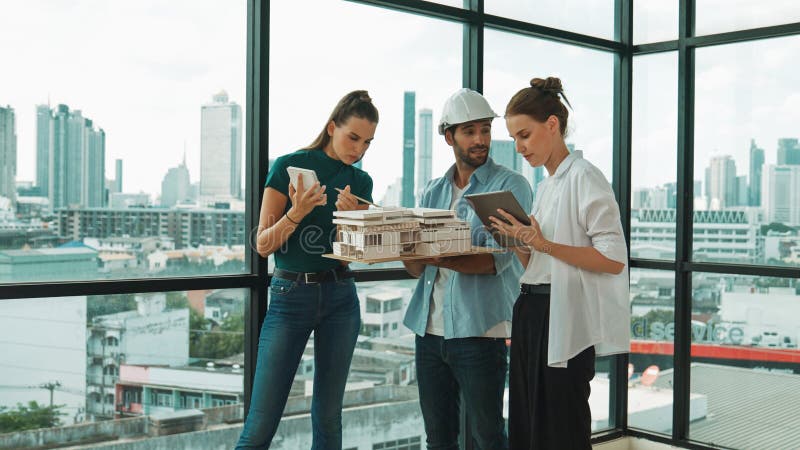 Engineer Holds House Model and Explain about House Construction ...