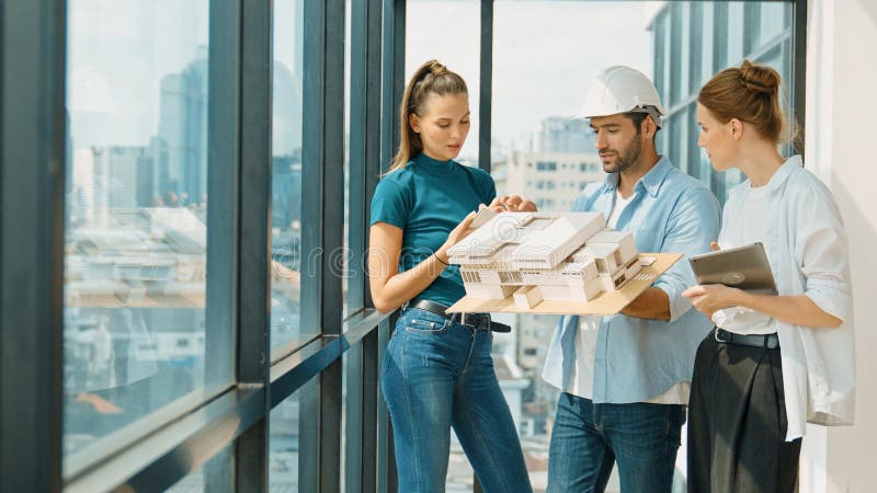 Engineer Holds House Model and Explain about House Construction ... Engineer Holds House Model and Explain about House Construction ...