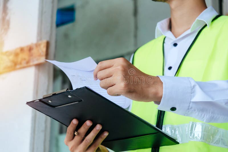 Engineer or Home Inspector in Green Reflective Jacket Checking Review ...