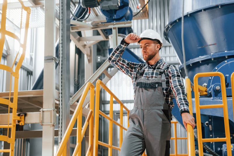 Engineer is Indoors. Construction Worker in Uniform is in the Factory ...