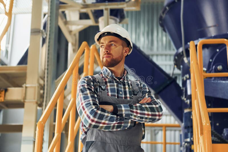 Engineer is Indoors. Construction Worker in Uniform is in the Factory ...