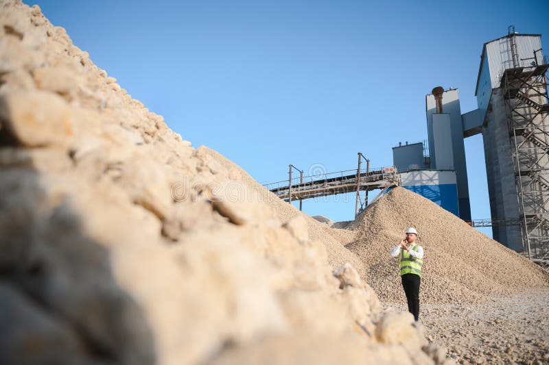 Engineer on an Industrial Background. Stone Crushing and Screening ...