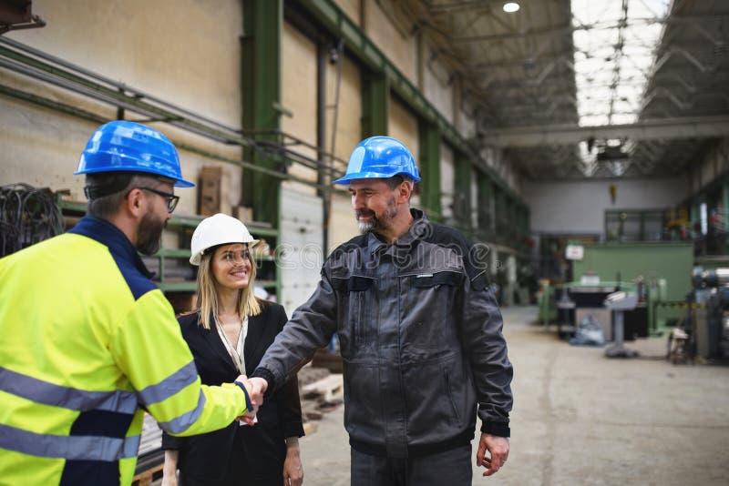 Engineer and Industrial Worker in Uniform Shaking Hands in Large Metal ...