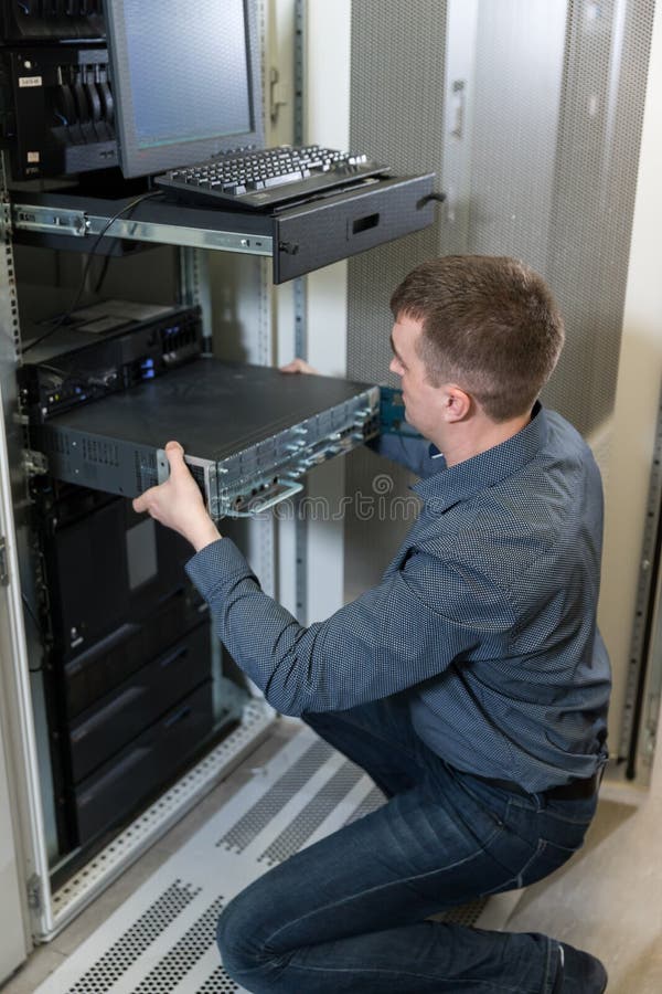 It Engineer Installs Equipment To Rack in Datacenter Stock Photo ...