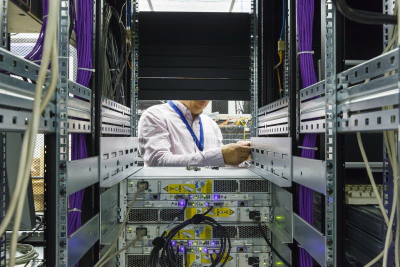 The Engineer Installs the New Equipment in the Server Rack of the Data ...