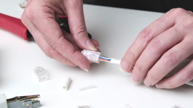 An Engineer Installs a New Connector on a Cable Using a Tool. Tool for ...