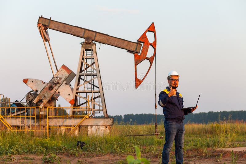 Engineer with a Laptop on the Background of an Oil Pump Stock Photo ...