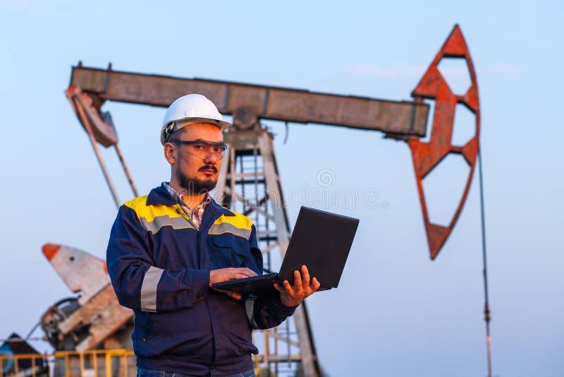 Engineer with a Laptop on the Background of an Oil Pump Stock Photo ...
