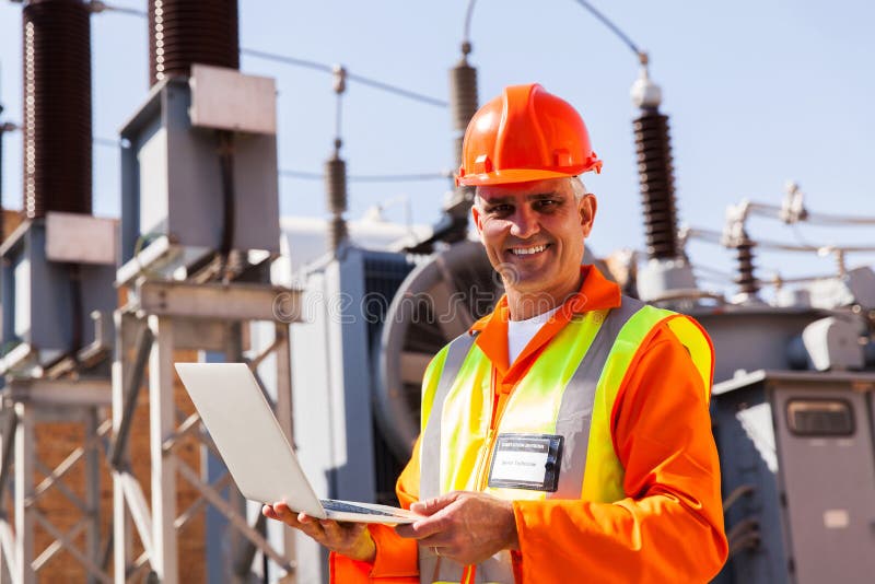 Engineer with laptop stock photo. Image of helmet, plant - 43847762
