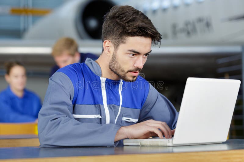 Engineer Looking at Laptop for Airplane Maintenance Stock Image - Image ...