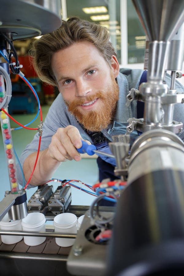 Engineer Maintaining Machinery in Factory Stock Photo - Image of ...