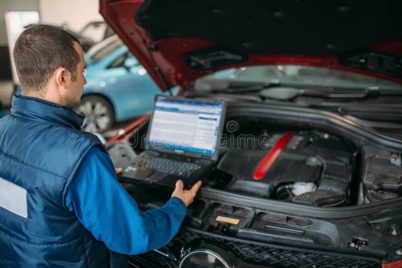 Engineer Makes Computer Diagnostics of Car Engine Stock Photo - Image ...