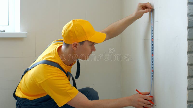 The Engineer Makes Markings on the Wall. Stock Image - Image of ...