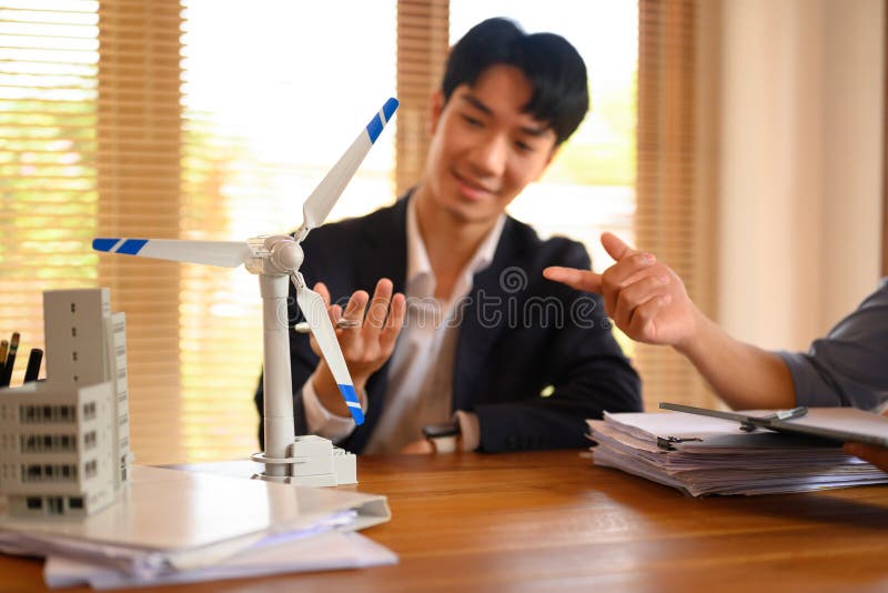 Engineer Man Explaining Wind Turbine Models To Colleagues Working on ...
