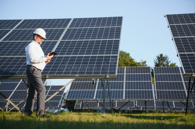 Engineer Man in Helmet in the Field of Solar Panels Stock Image - Image ...