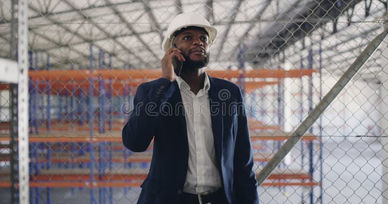 Engineer, Man and Phone Call at Warehouse, Talking and Planning Project. Smartphone, African ...