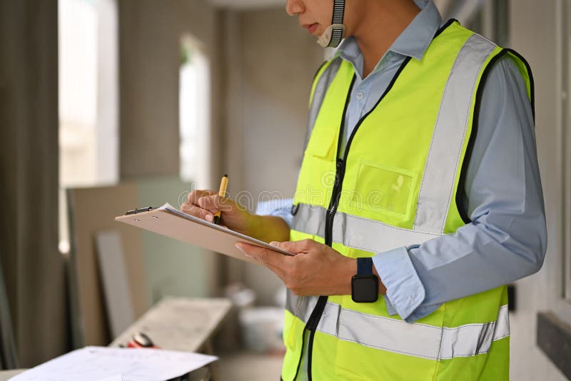 Engineer Man in Reflective Jackets Writing on Clipboard, Inspecting ...