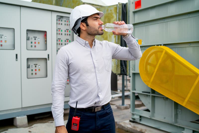 Engineer Man or Technician Worker Drink Water from Bottle and Stand in ...