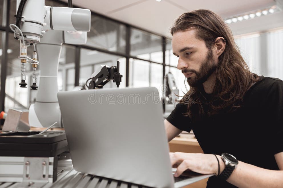 Engineer Man University Student Learn Control Operate and Program Industry Robot Arm with Laptop ...