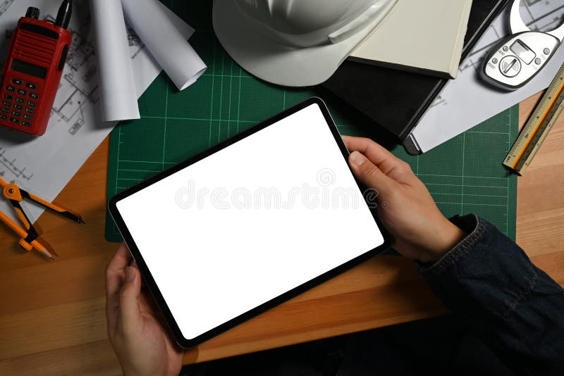 Engineer Man Using Digital Tablet and Working with Blueprints at ...